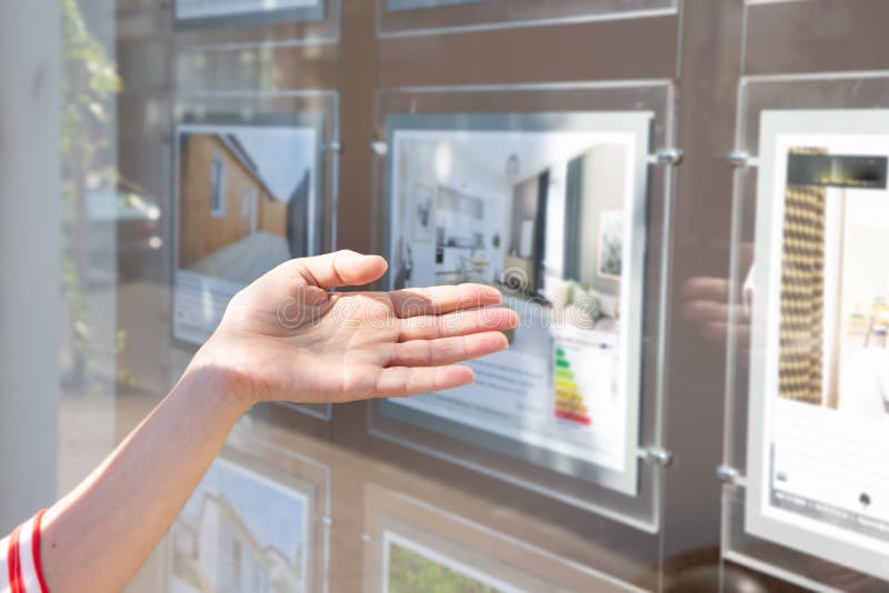 Woman in Front of Real Estate Agent Showcase Window Stock Photo - Image ...