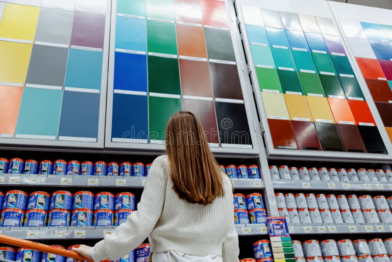 Woman in Front of Samples of Facade and Interior Paint Color Palette on ...