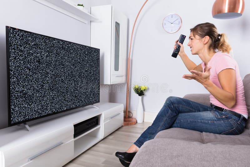 Woman Frustrated with a TV Screen Glitch Stock Photo - Image of ...
