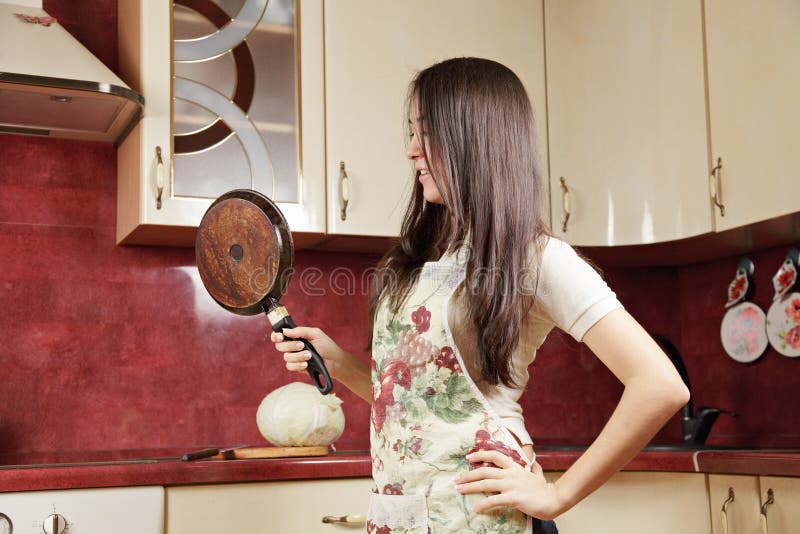 Woman with frying pan stock image. Image of young, kitchen - 23294723