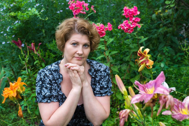 Woman in Garden Surrounded by Flowers Stock Image - Image of inhales ...