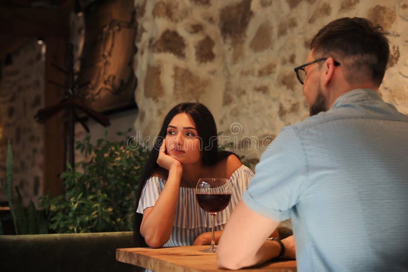 Young Woman Getting Bored during Date with Man at Cafe Stock Photo ...