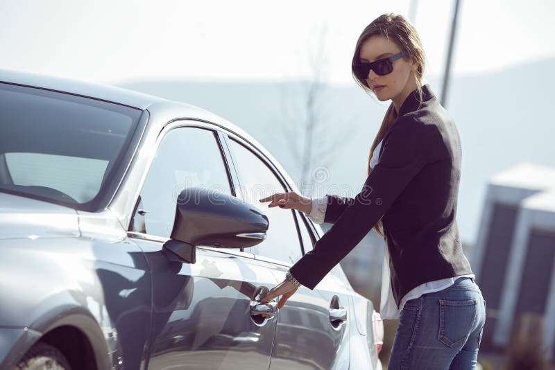 Woman getting in a car stock photo. Image of lifestyle - 38027212