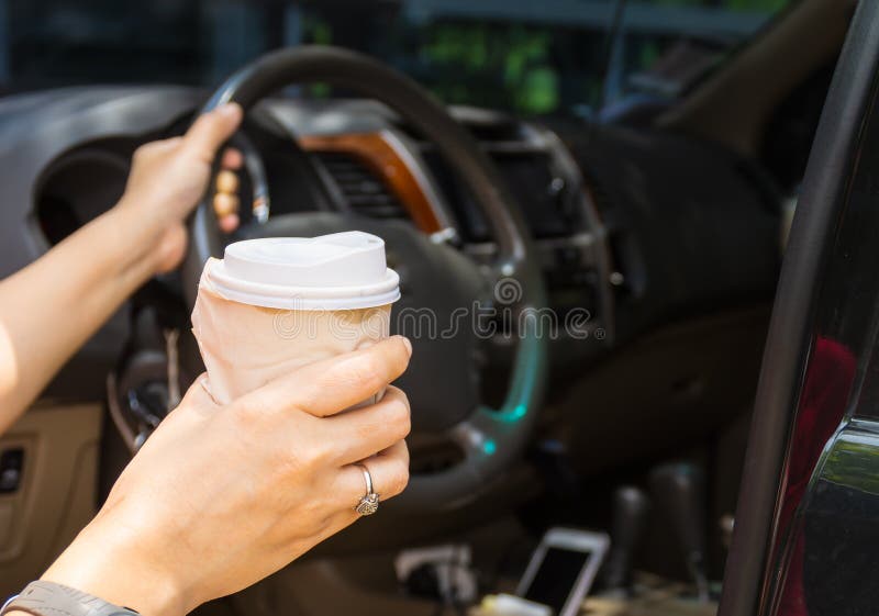 Woman Getting in a Car with a Takeaway Cup of Hot Coffee. Stock Photo ...