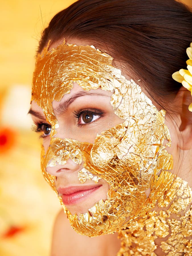 Woman Getting Facial Mask . Stock Image - Image of massage, gold: 27184363