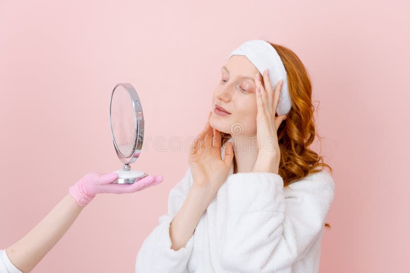 A Woman is Getting Her Face Done by a Woman in a White Robe Stock Photo ...