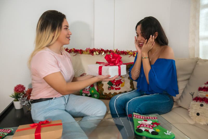 Woman Giving a Gift Box To Another Stock Image - Image of lifestyles ...