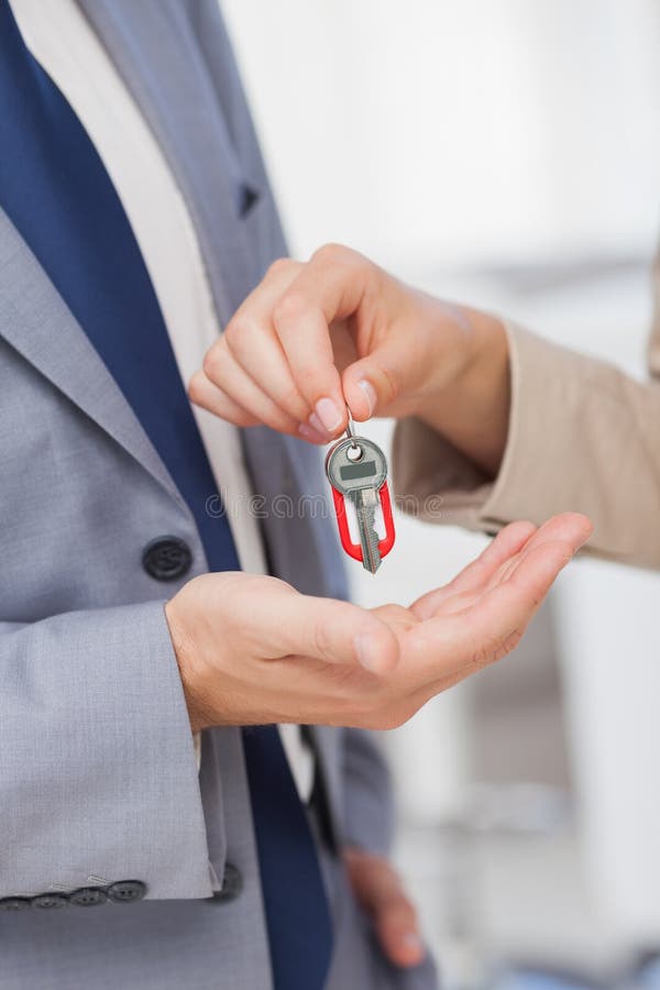 Woman giving key stock photo. Image of business, dressed - 32234322