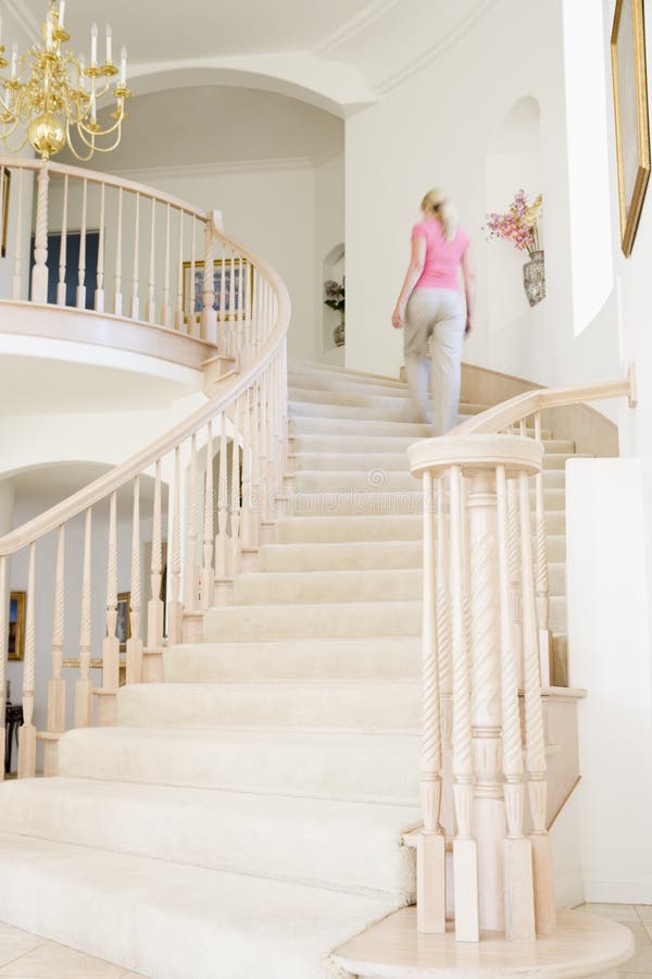 Woman Going Up Staircase in Luxurious Home Stock Photo - Image of ...