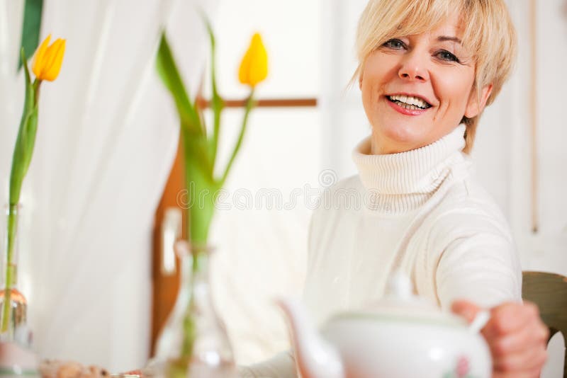 Woman Grabbing Coffee or Tea Pot Stock Image - Image of grab, chair ...