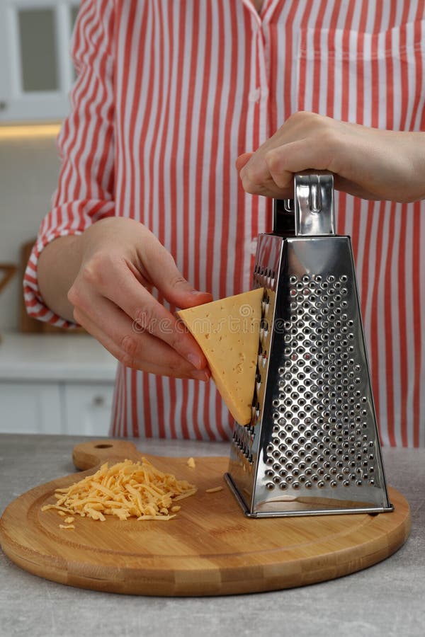 Woman Grating Cheese at Kitchen Table, Closeup Stock Photo - Image of ...