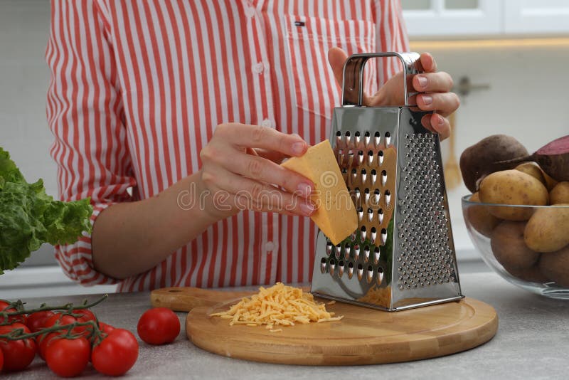 Woman Grating Cheese at Kitchen Table, Closeup Stock Photo - Image of ...