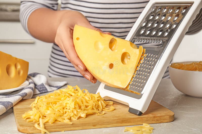 Woman Grating Fresh Cheese at Table Stock Photo - Image of diet, dairy ...