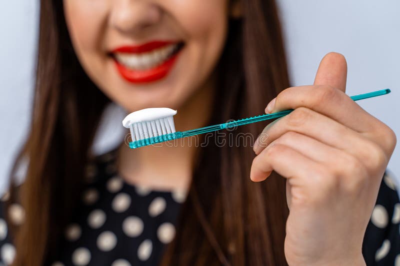 Woman with Great Teeth Holding Tooth-brush in Front of Camera. Blurred ...