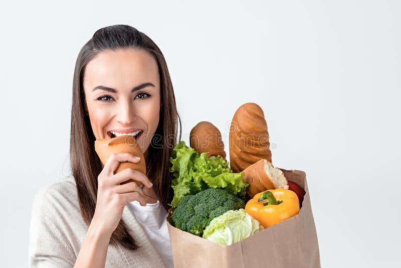 Woman with Grocery Bag Biting Bread on White Stock Image - Image of ...