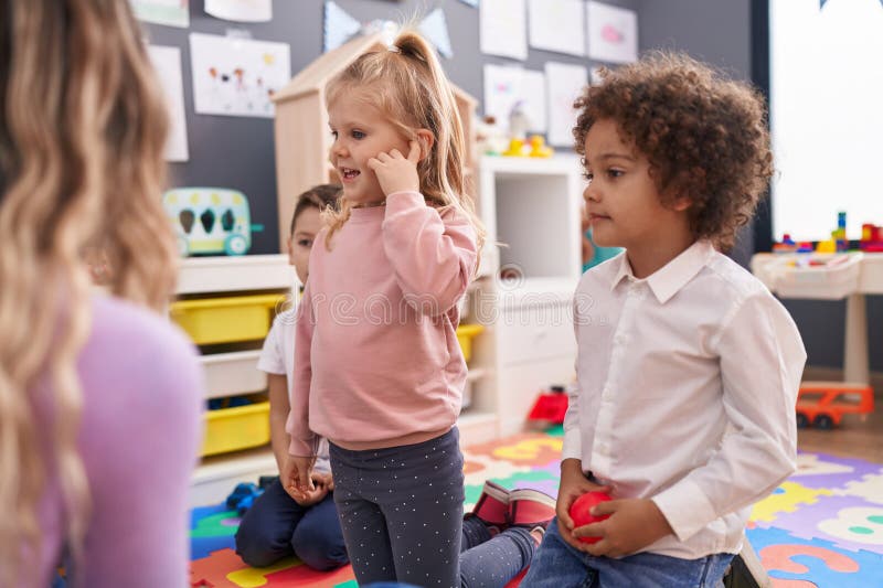 Woman and Group of Kids Having Lesson at Kindergarten Stock Photo ...