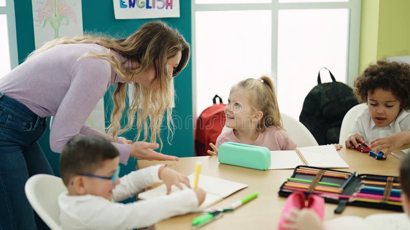 Woman and Group of Kids Having Lesson Sitting on Table at Classroom ...