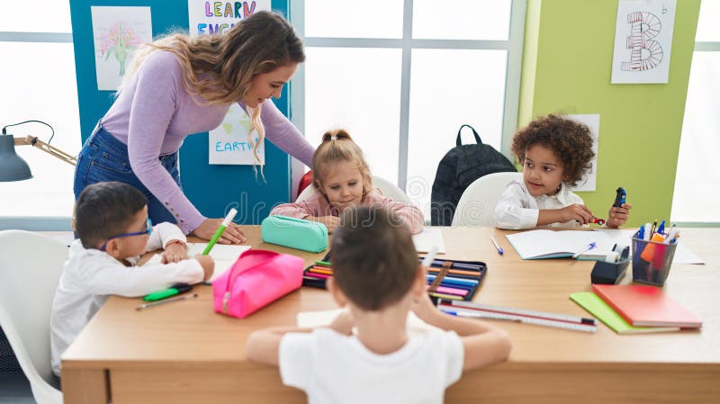 Woman and Group of Kids Having Lesson Sitting on Table at Classroom ...