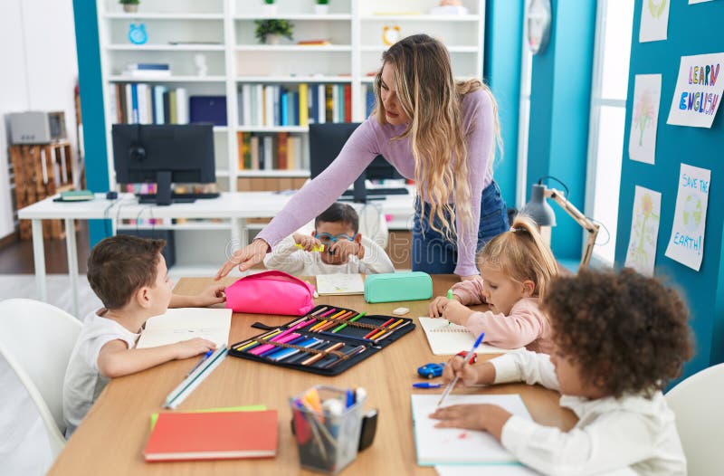 Woman and Group of Kids Having Lesson Sitting on Table at Classroom ...