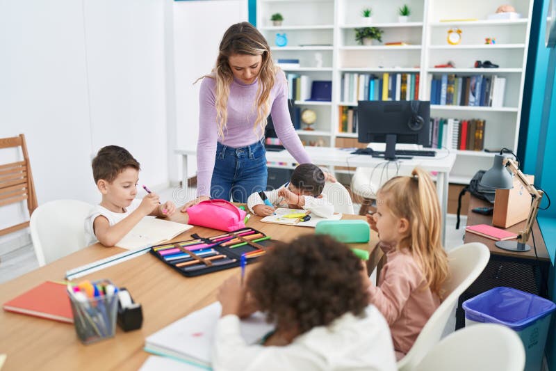 Woman and Group of Kids Having Lesson Sitting on Table at Classroom ...