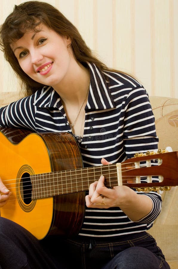 Woman with a guitar stock photo. Image of adult, brunette - 7671666
