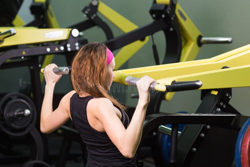 Beautiful Woman at the Gym Exercising on a Machine. Stock Photo - Image ...