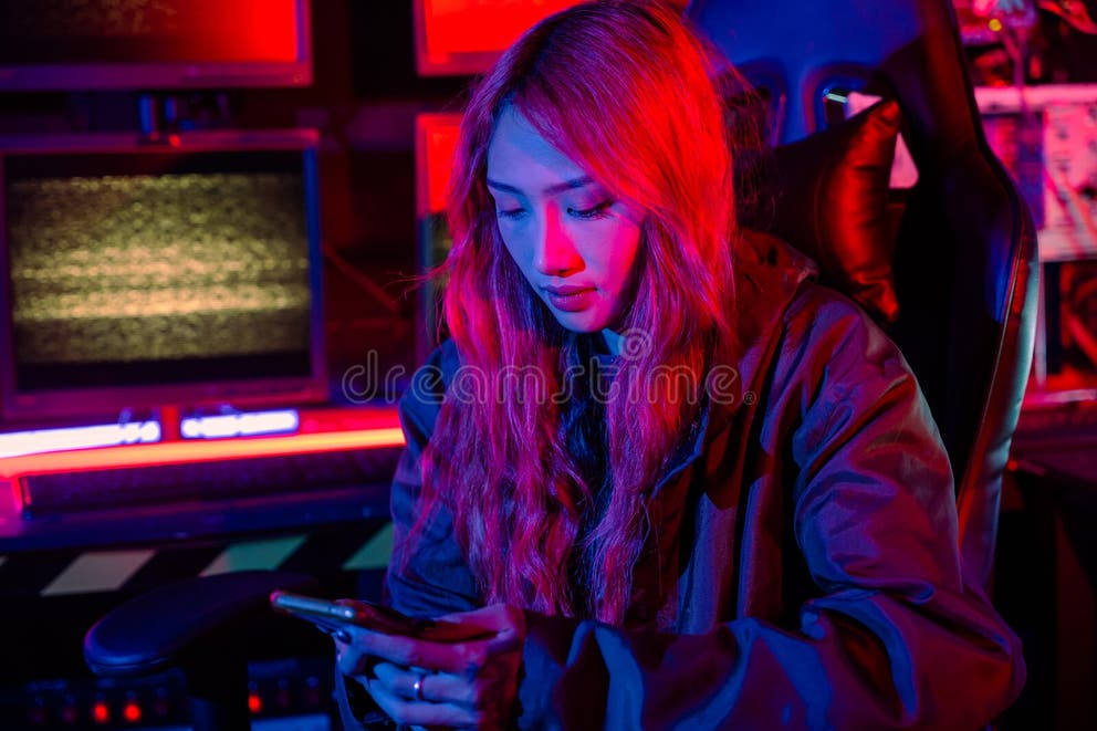 Woman Hacker. Asian Woman Wearing Hood Working at Computer and Mobile ...