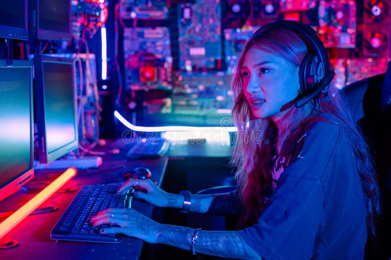Woman Hacker Sitting In Front Of A Computer Typing On Keyboard Hacking Servers Stock Image