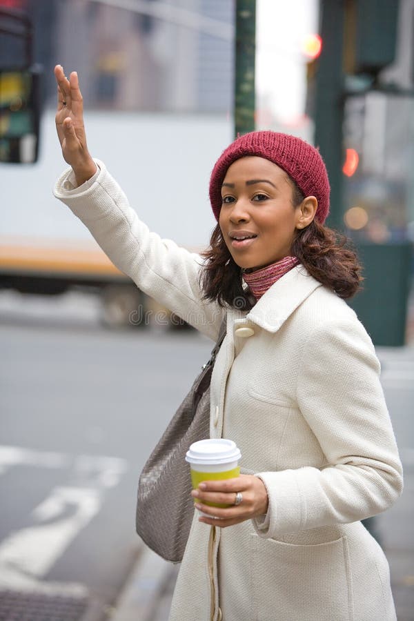Woman Hailing a Cab stock photo. Image of calling, american - 7934296