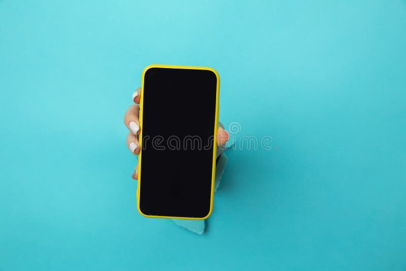 Woman Hand in the Blue Paper Hole Holding Smartphone Stock Photo ...