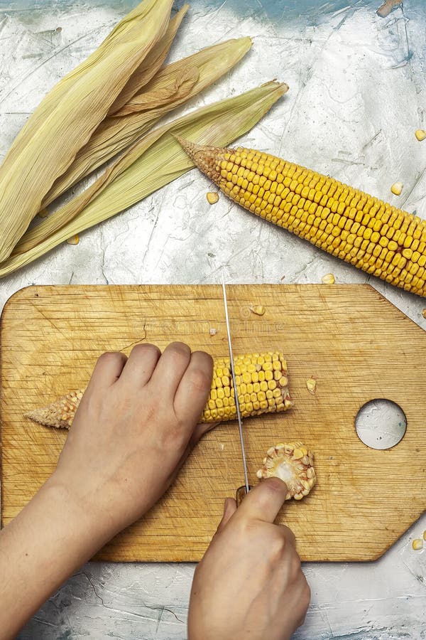 Woman Hand Cutting Sweet Corn on Cutting Board Stock Photo - Image of ...