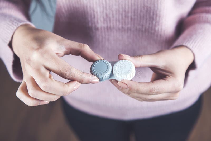Woman hand holding lenses stock image. Image of portrait - 172343015