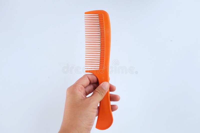 Woman Hand Holding Orange Comb Isolate on a White Background. Stock ...