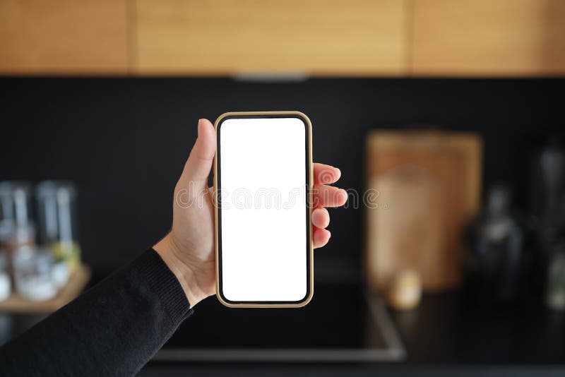 Woman Hand Holding Smartphone with Vertical White Screen on Kitchen at ...