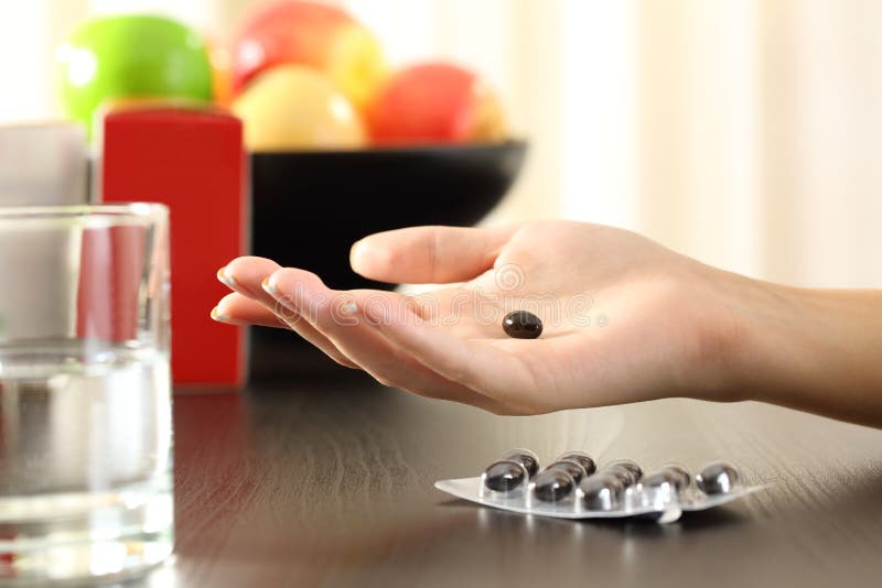Woman Hand Holding a Vitamin Complex Pill Stock Image - Image of glass ...