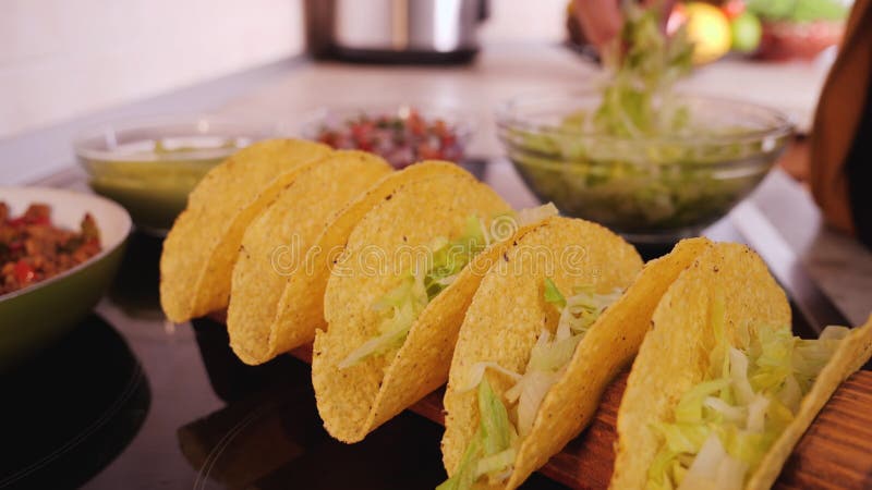 Woman Hand Making Tacos, Adding a Layer of Lettuce Stock Footage ...