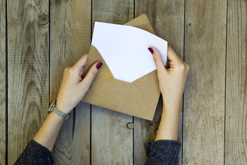 Woman Hand Opening Envelope on Wooden Table. Stock Photo - Image of ...