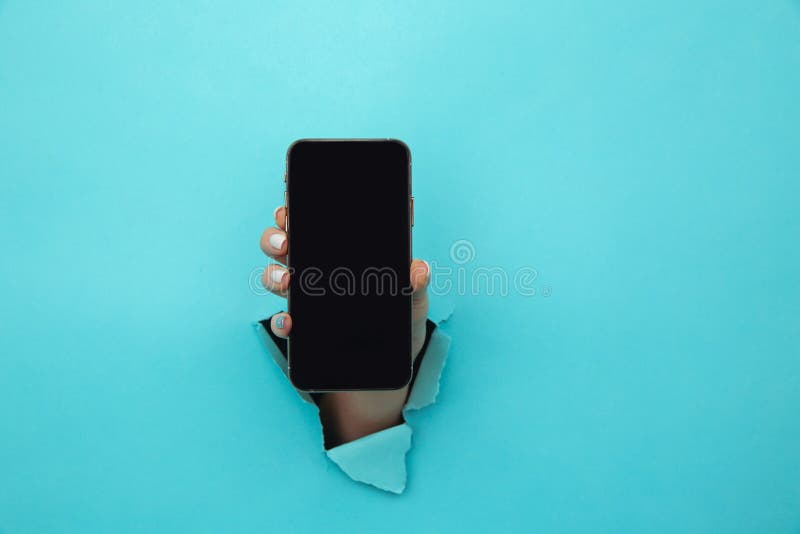 Woman Hand in the Paper Hole Holding Smartphone. Mobile Application ...