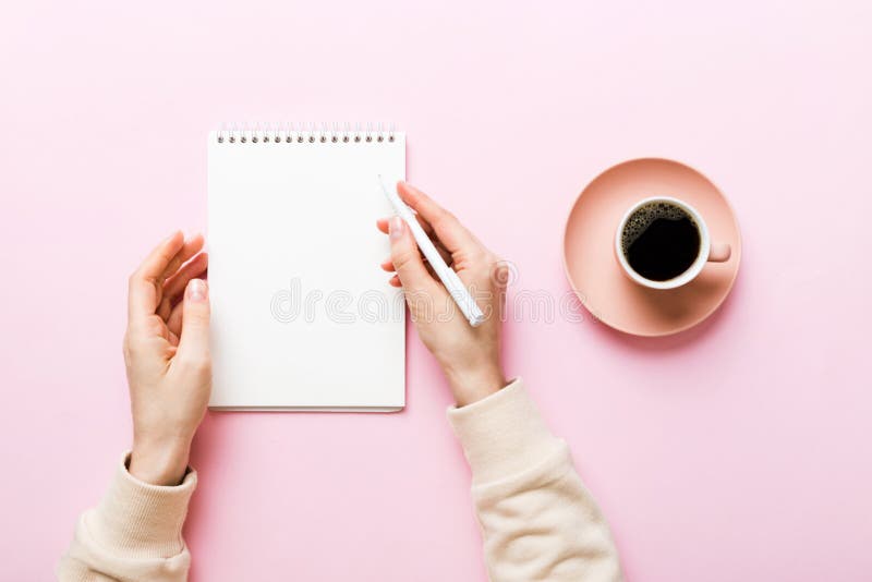 Woman Hand with Pencil Writing on Notebook and Hold Coffee Cup. Woman ...