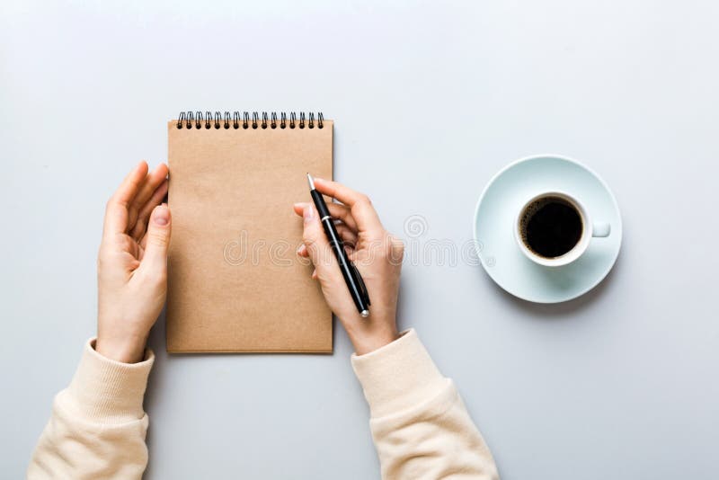 Woman Hand with Pencil Writing on Notebook and Hold Coffee Cup. Woman ...