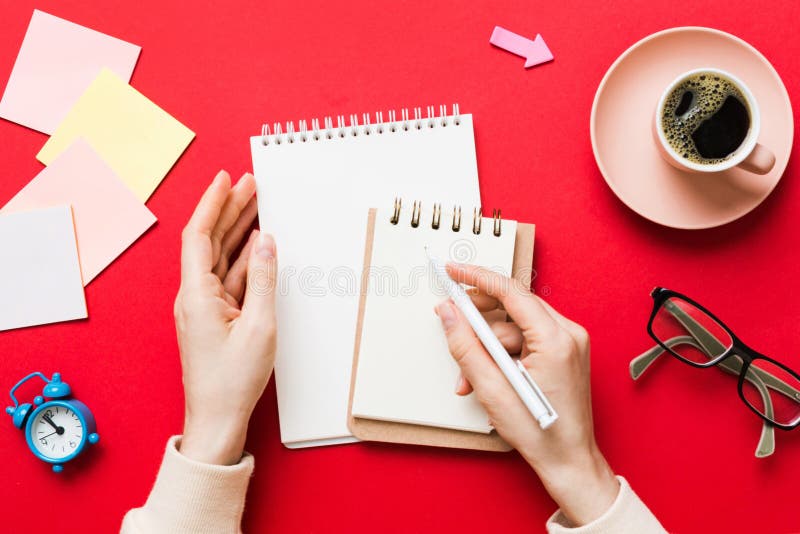 Woman Hand with Pencil Writing on Notebook and Hold Coffee Cup. Woman ...