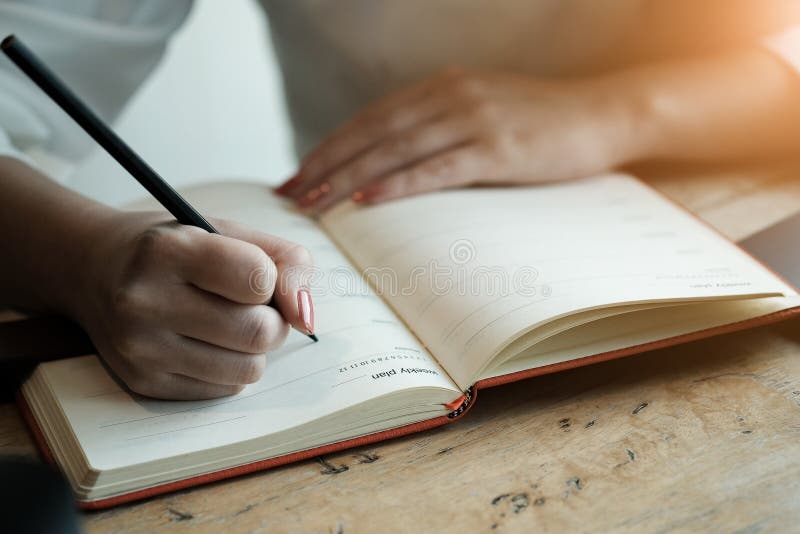 Woman Hand with Pencil Writing on Notebook. Making Notes in Notebook ...