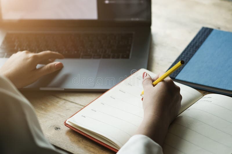 Woman Hand with Pencil Writing on Notebook. Making Notes in Notebook ...