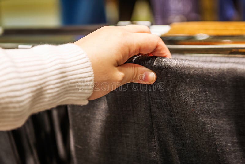 Woman Hand Pick Pick Trousers in a Store Stock Photo - Image of maroon ...
