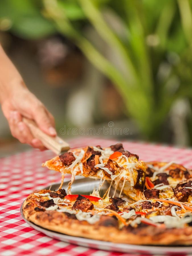 Woman Hand Takes a Slice of Pizza with Spatula on Table. Stock Image ...