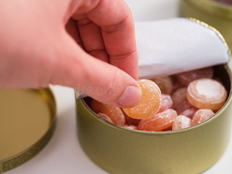 Woman Hand Taking a Candy from a Tin Box Full of Fruit Drops Candies ...