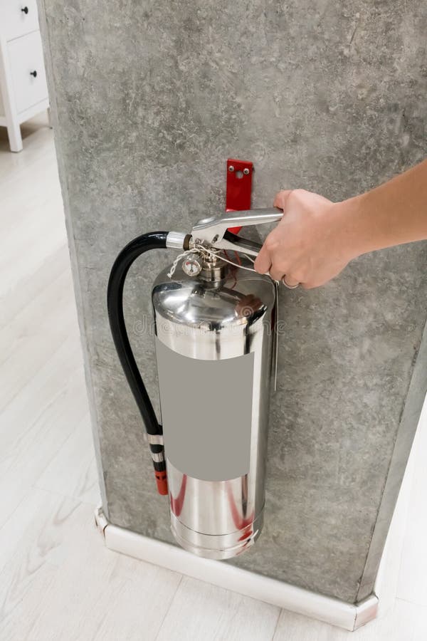 Woman Hand Touching and Checking the Chrome Fire Extinguisher Stock ...