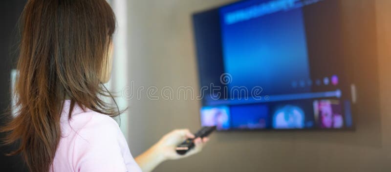 Woman Hand Using Remote Controller for Adjust Smart TV Inside the ...