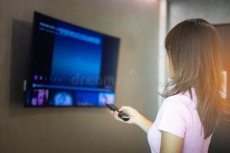 Woman Hand Using Remote Controller for Adjust Smart TV Inside the ...