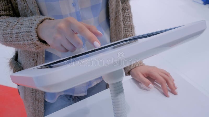 Woman Hand Using Touchscreen Display of Floor Standing White Tablet ...